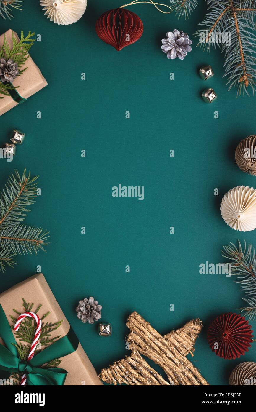 Vertical Christmas frame with gift boxes, paper decorations and spruce ...