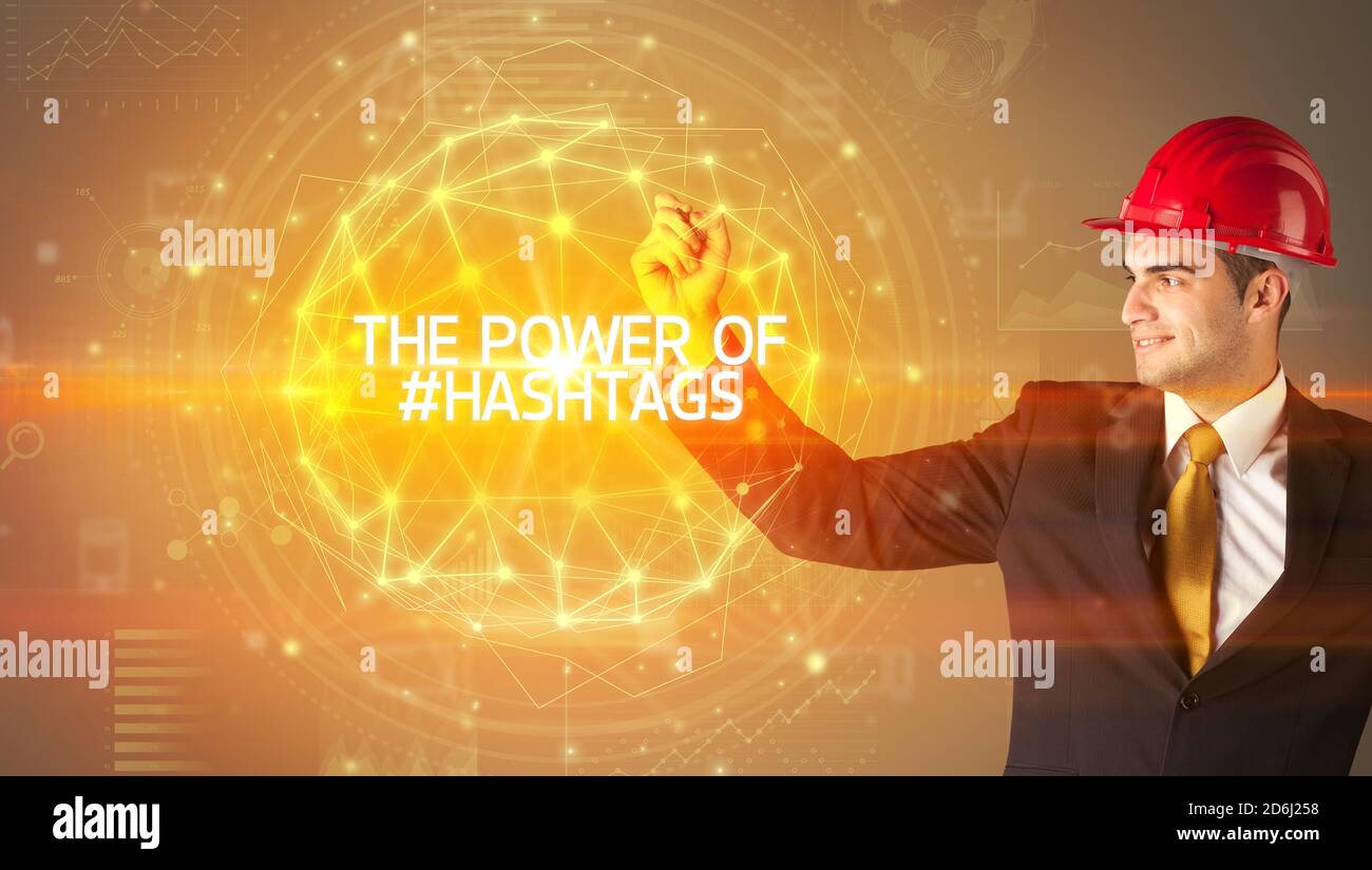 Handsome businessman with helmet drawing THE POWER OF #HASHTAGS ...
