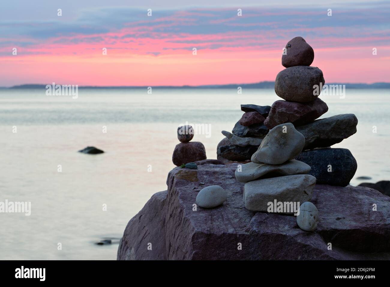 Stone pyramids on the beach at sunset, Moenchgut peninsula, Ruegen ...