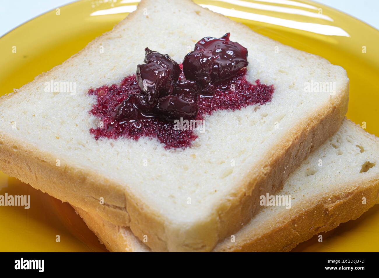 Bread and cherry jam in yellow glass dish Stock Photo - Alamy