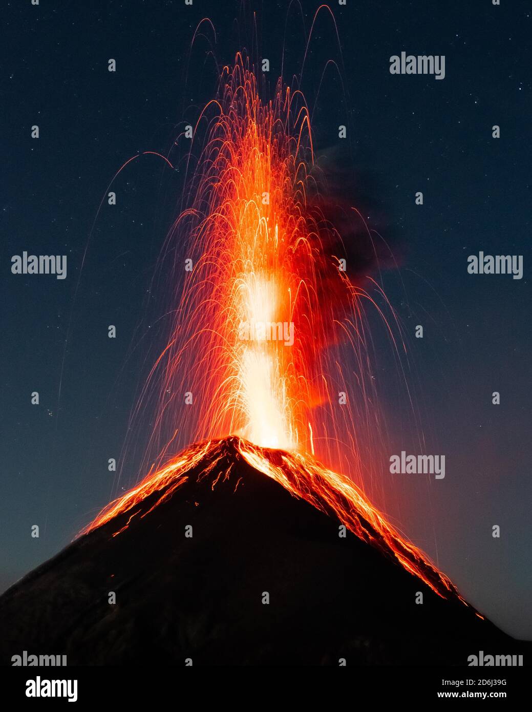 Glowing lava and smoke spitting volcano, volcanic eruption at night ...