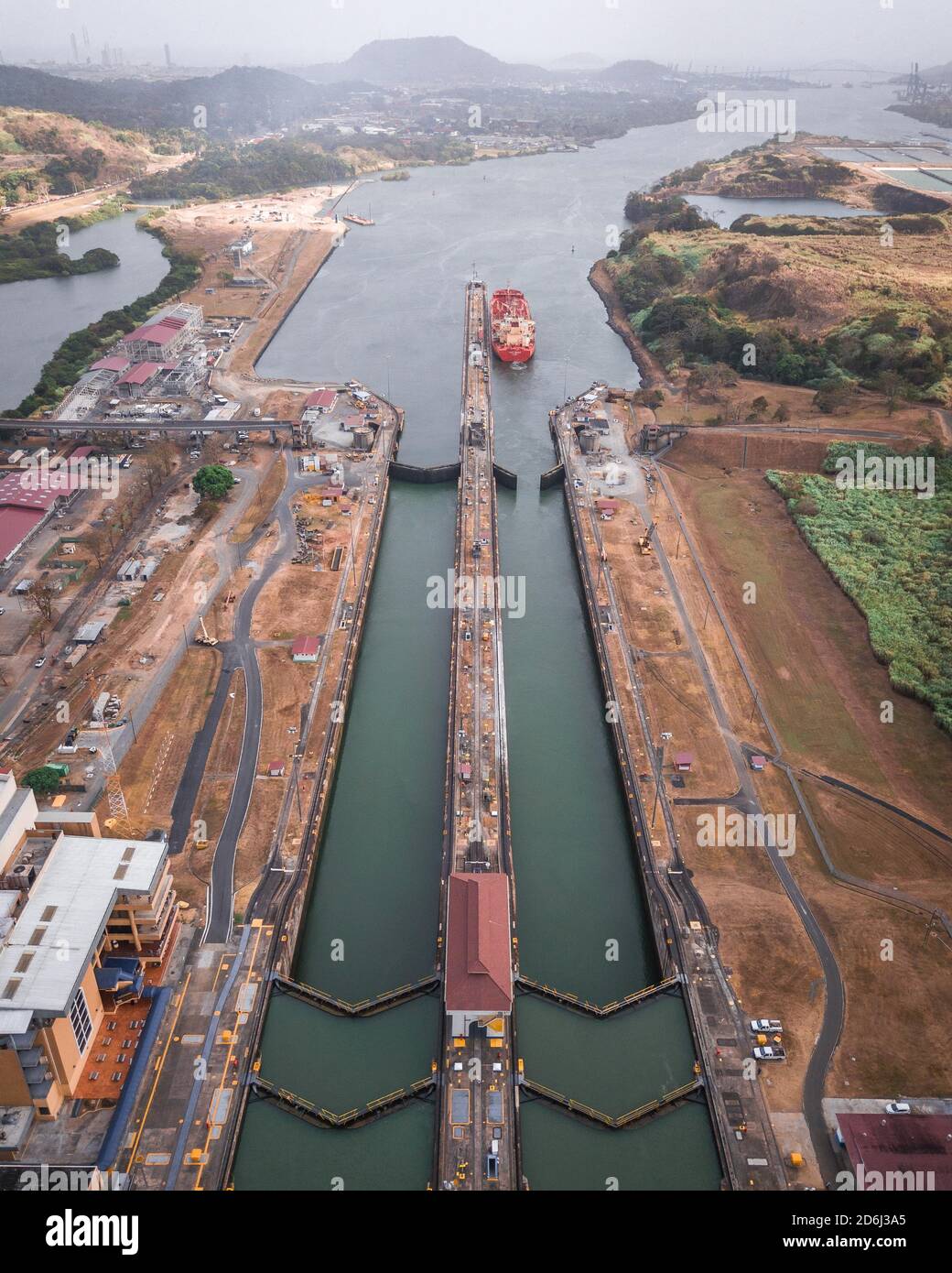 Aerial view, cargo ship at the lock in the Panama Canal from above ...