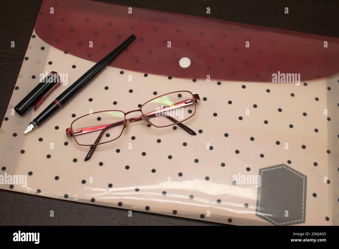 Glasses, fountain pen and document file on table Stock Photo - Alamy