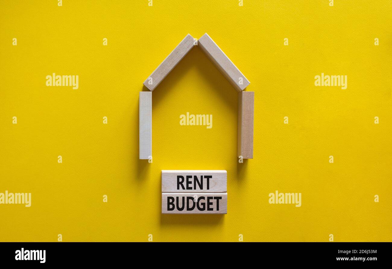 Model of a wooden house. Words 'rent budget' on wooden blocks. Copy ...