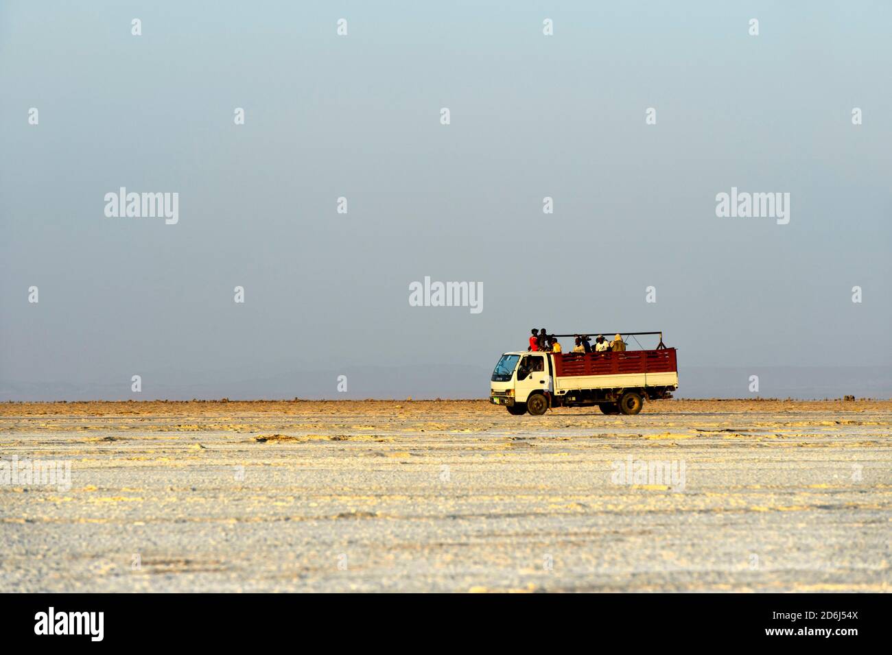 Truck drives with workers from the salt mine across the Assale Salt ...