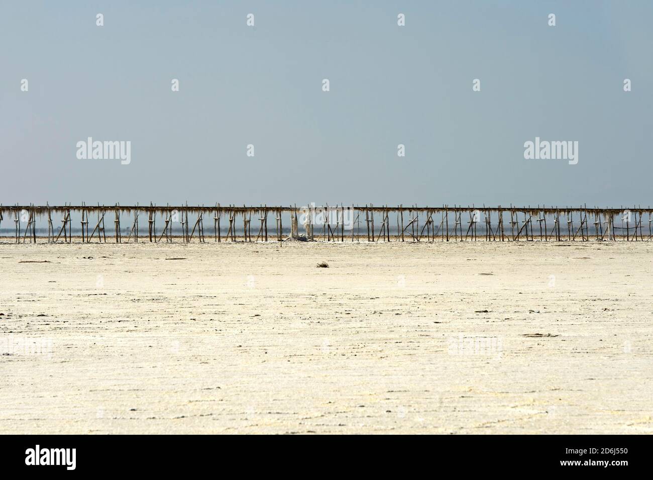 Pipeline on stilts on the Assale Salt Lake for the transport of brine ...