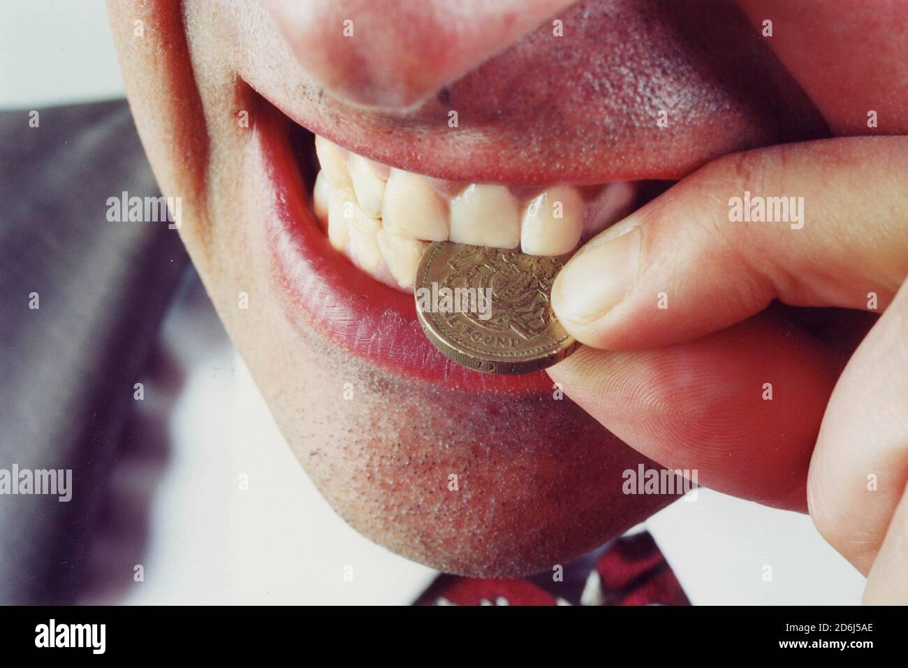 Man bites into a British pound, Currency, Berlin, Germany Stock Photo ...