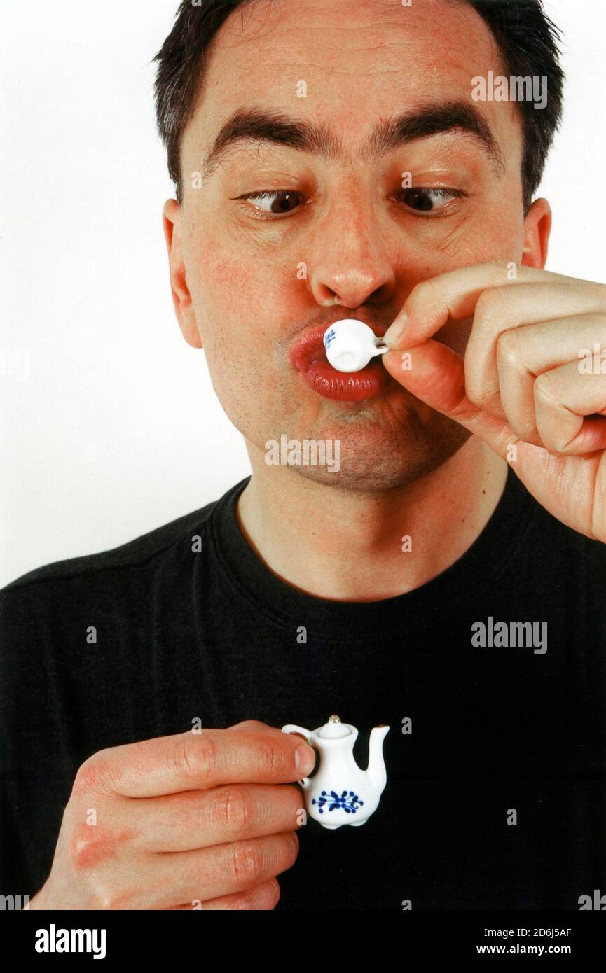 Man with tiny teapot and cup hi-res stock photography and images - Alamy