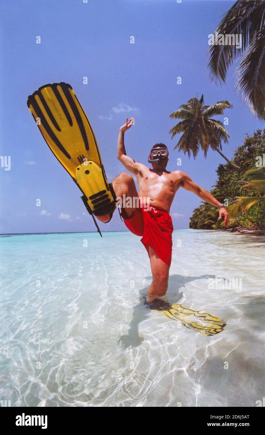 Man with fins and diving goggles on the beach hi-res stock photography ...