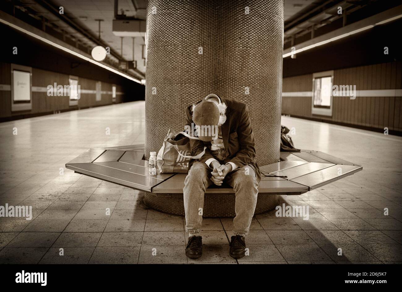 Homeless person, Berber, sitting in the waiting area of a suburban ...