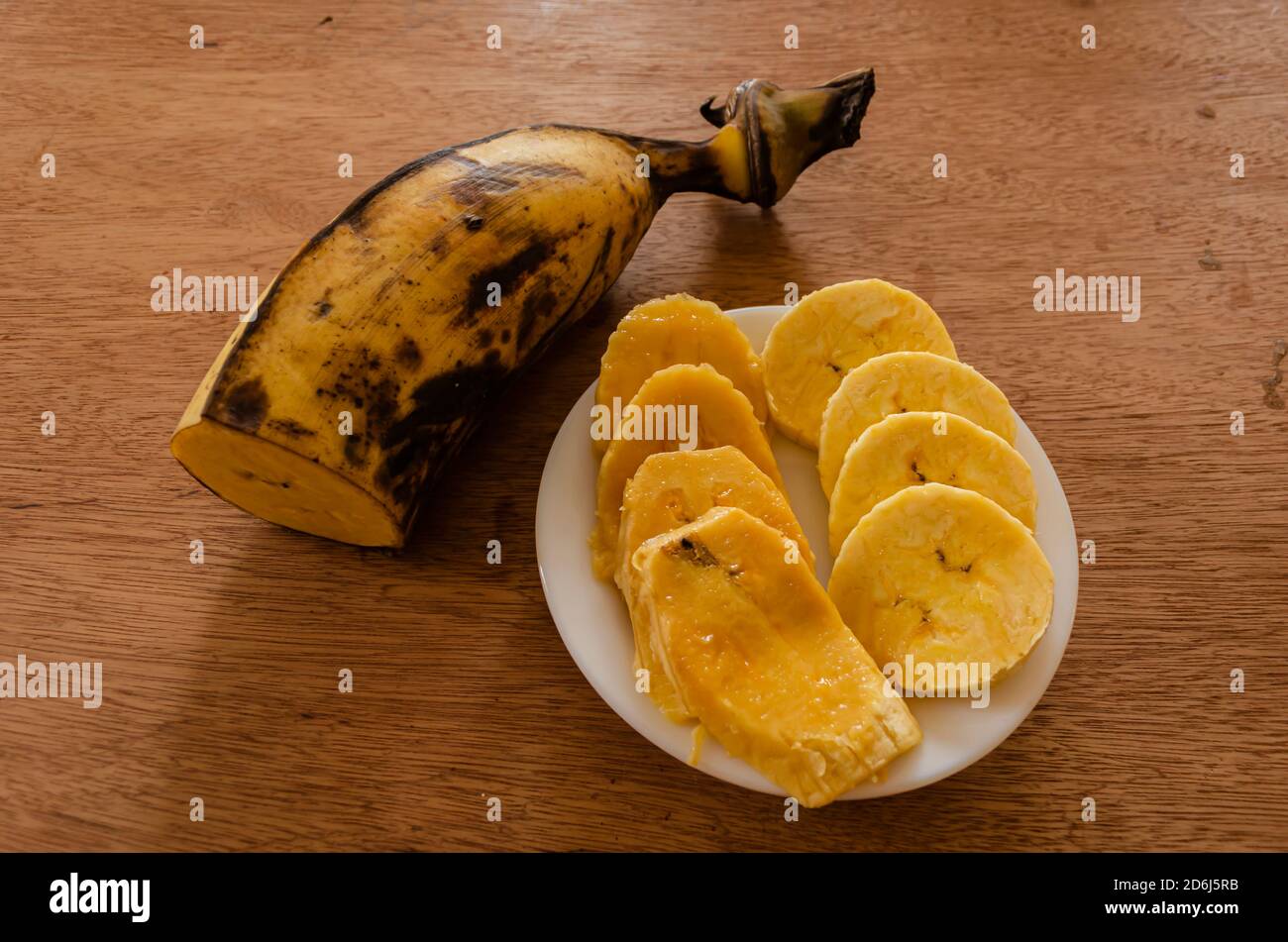 Cut Unripe Plantain And Slices Stock Photo - Alamy