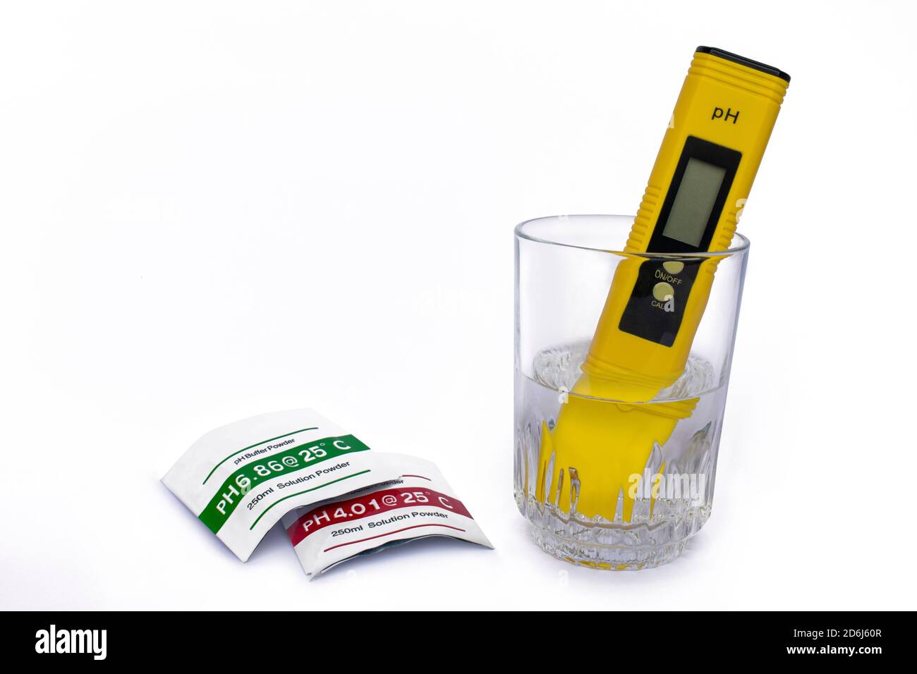 pH meter measuring the pH of the water in the glass on isolated white ...