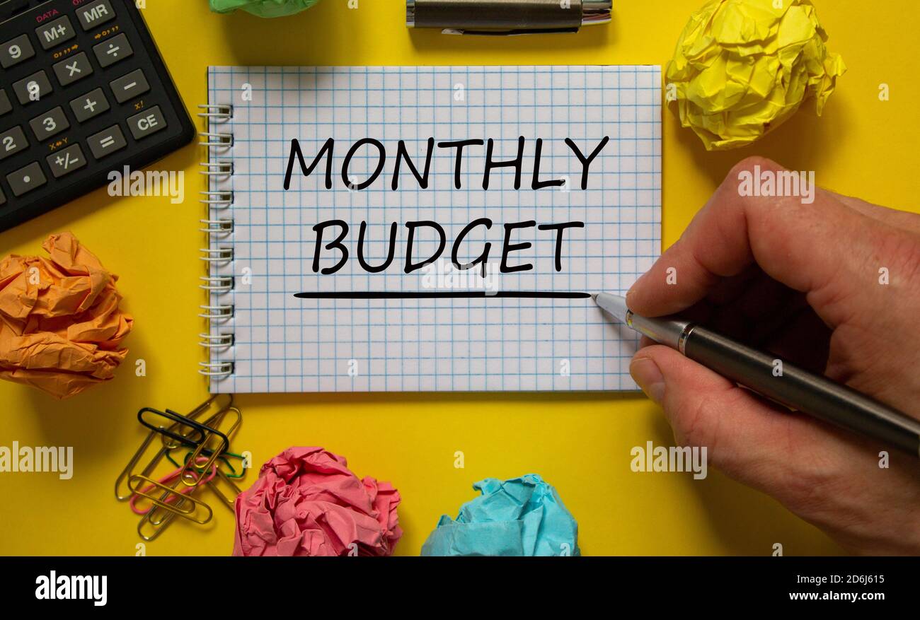 Mail hand writing 'monthly budget' on white note, beautiful yellow ...