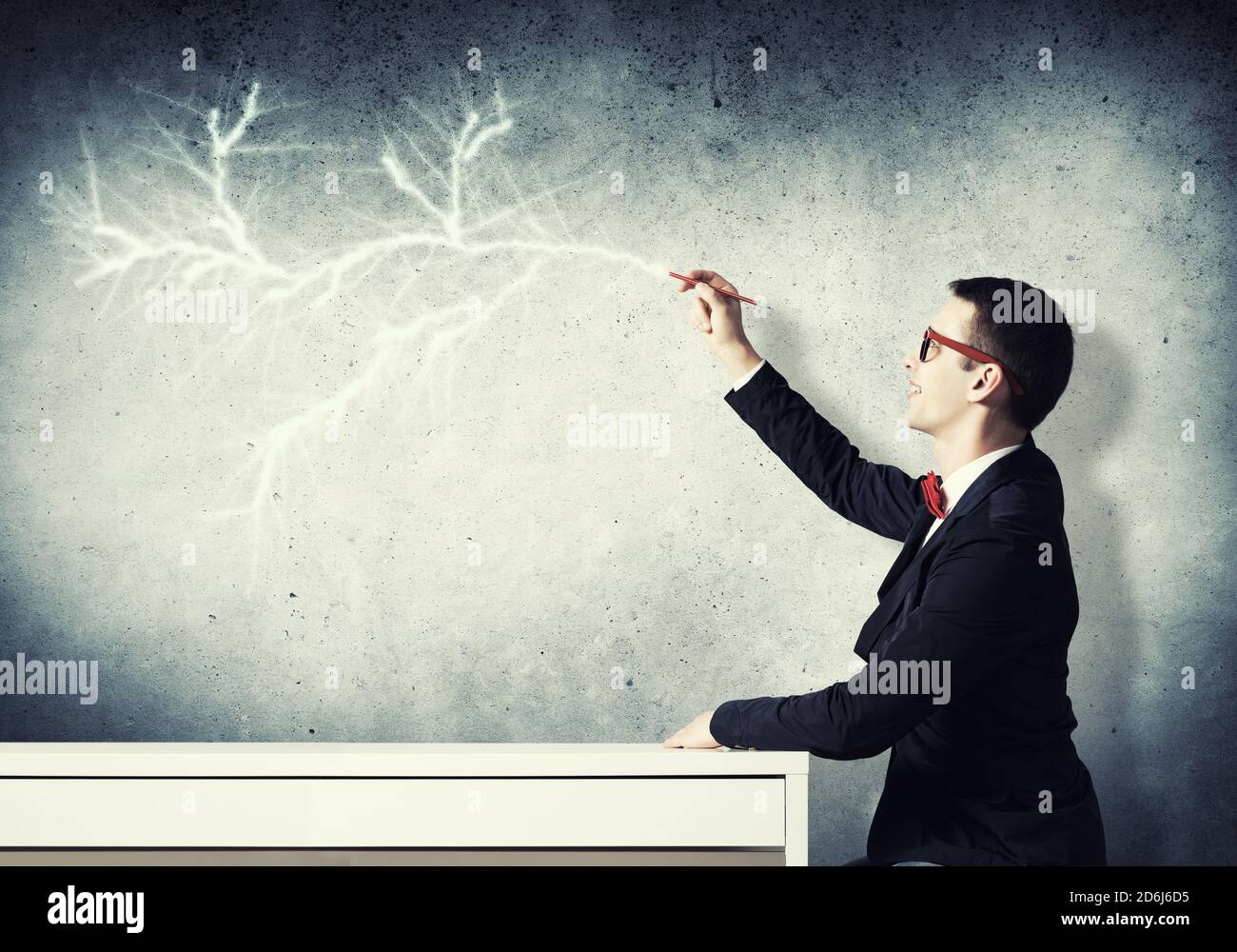 Smart guy draw on wall Stock Photo - Alamy