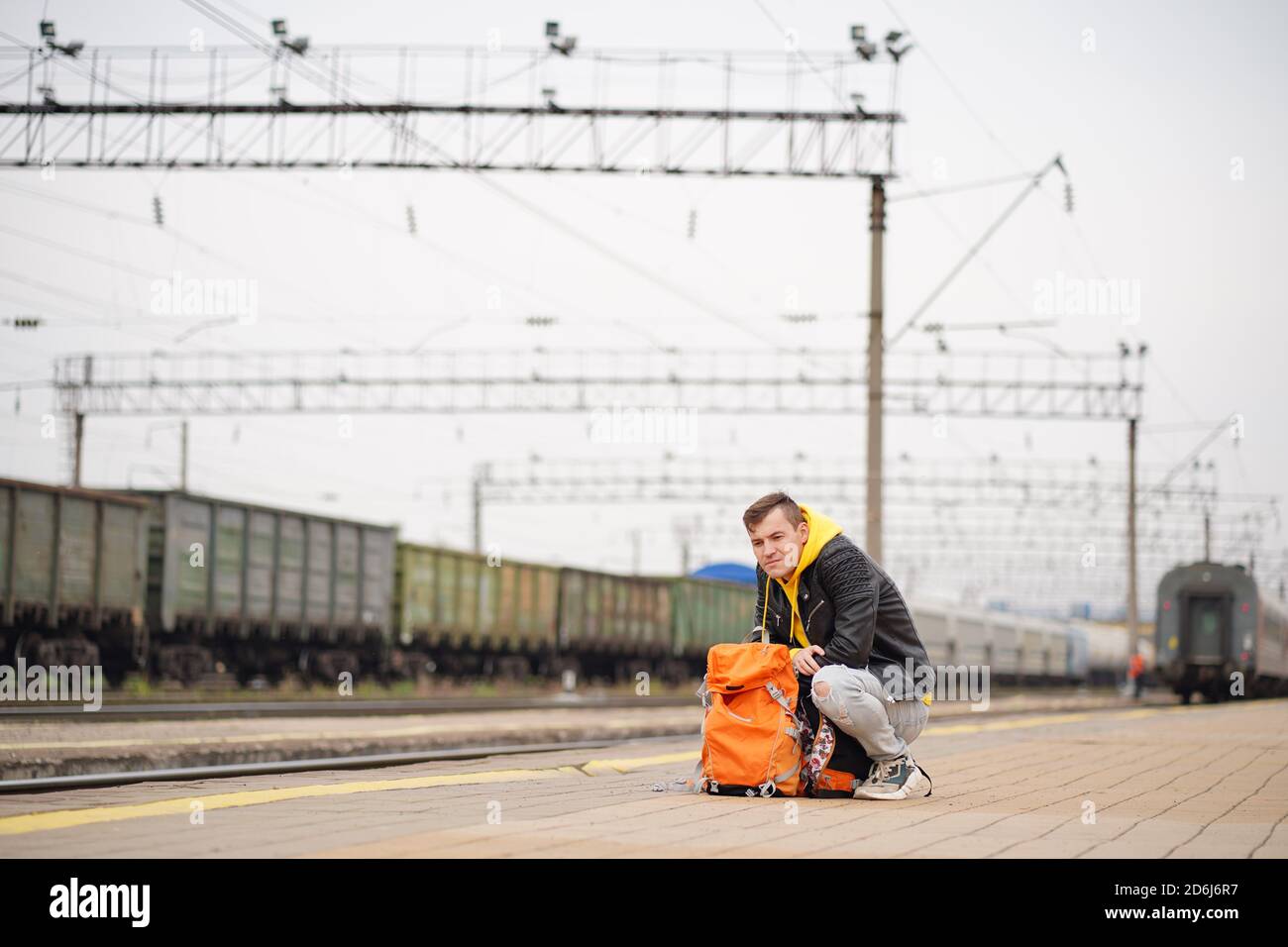 Man sitting on railway platform hi-res stock photography and images - Alamy