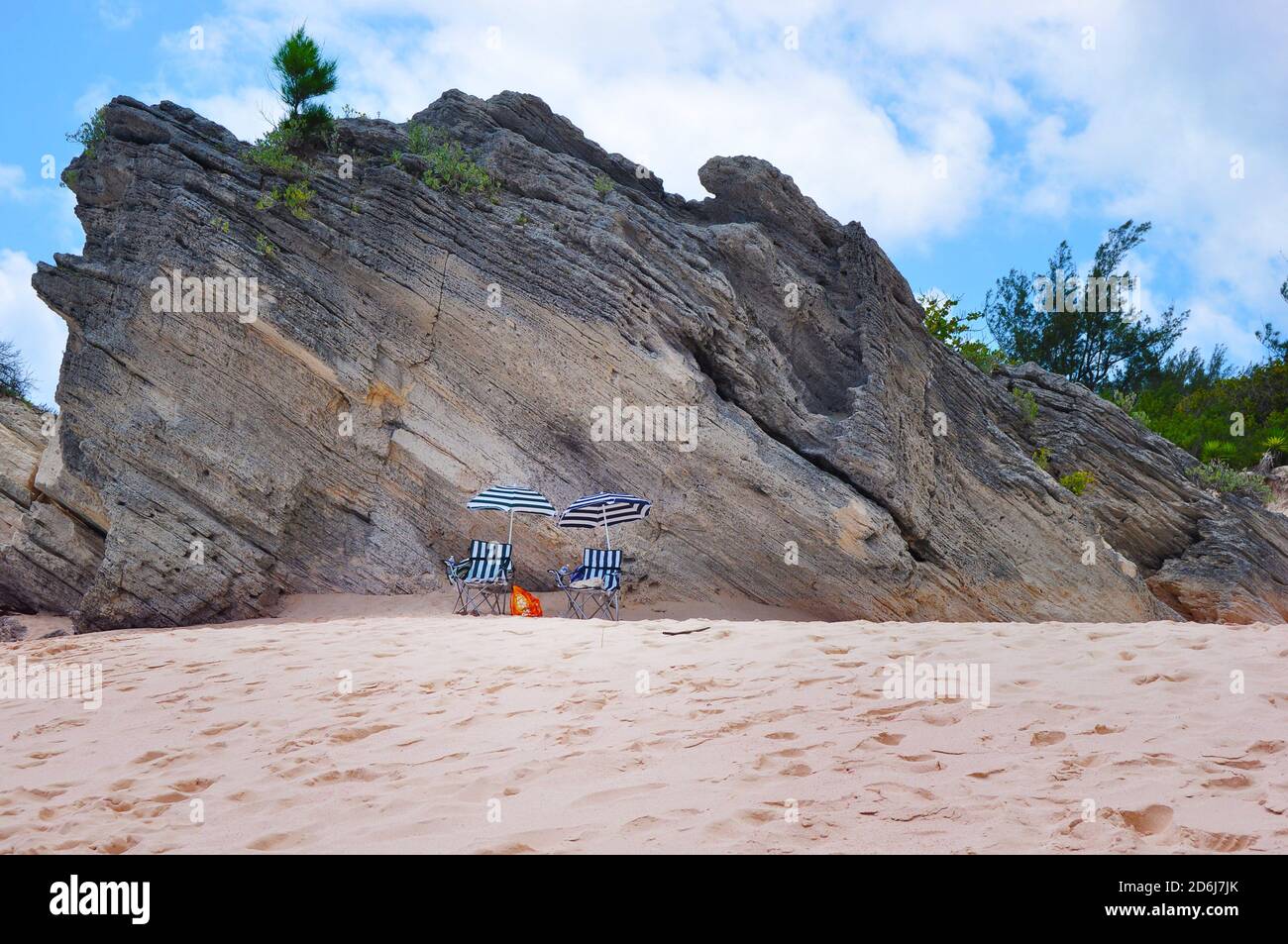 Bermuda pink sand beach and two beach chairs by the rock, Bermuda ...