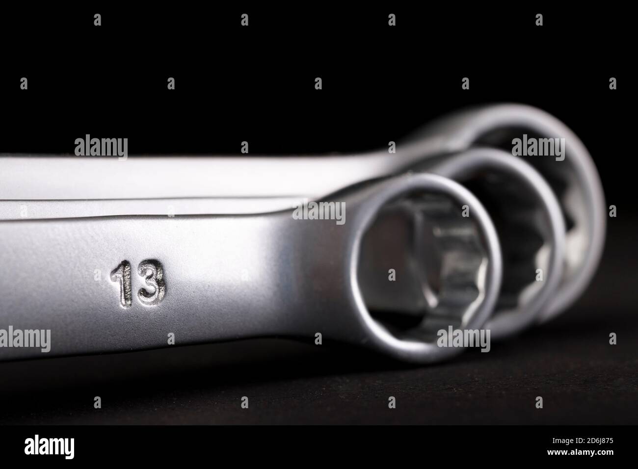 Metal flat keys on a dark table. Accessories for mechanics and builders ...