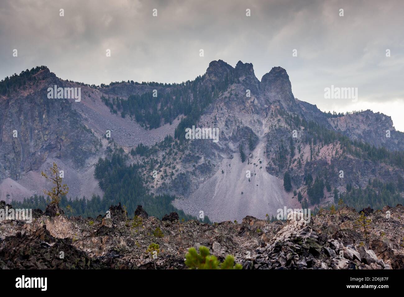 Paulina Peak standing tall in a stormy sky with rock slides down the ...