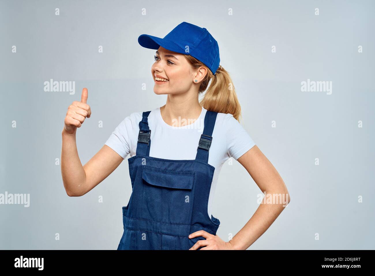 Woman in working uniform blue cap service lifestyle service Stock Photo ...