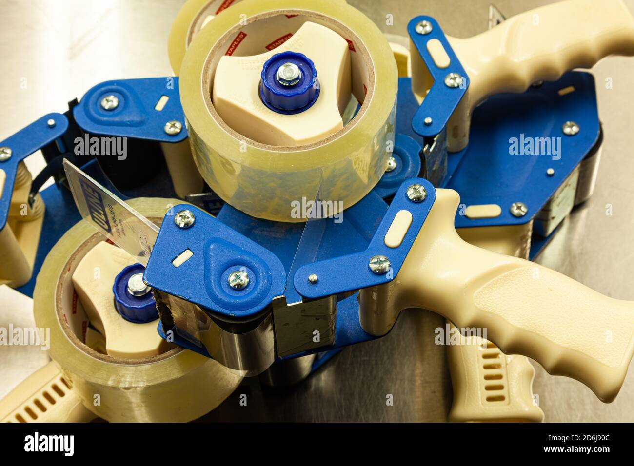 Abstract array of adhesive tape guns in a packaging facility Stock ...