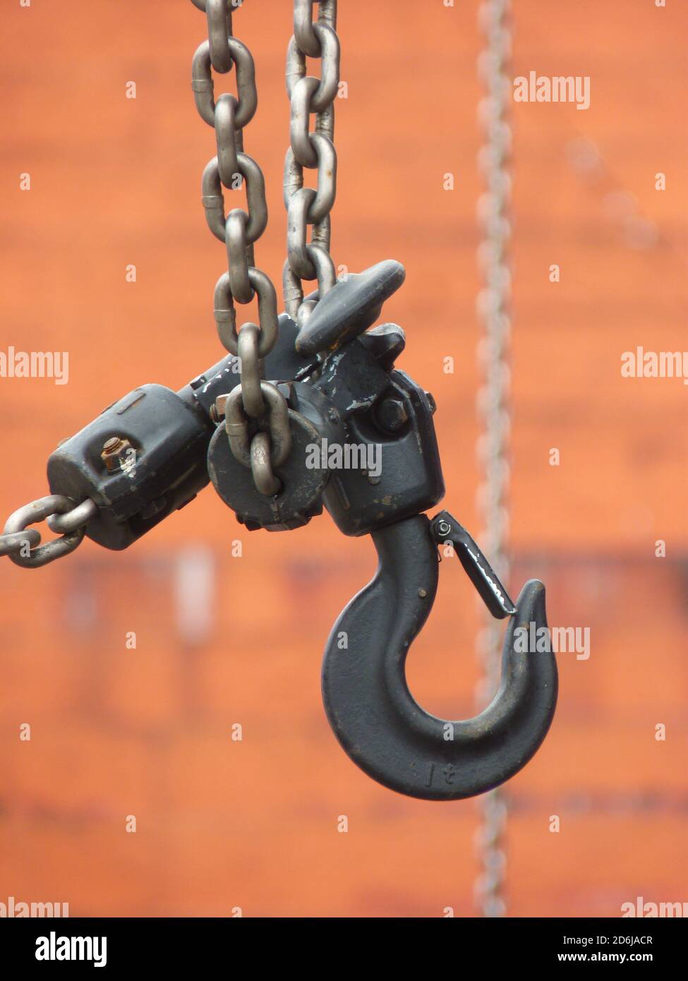 Vertical shot of a metal hook with chains attached to it Stock Photo ...