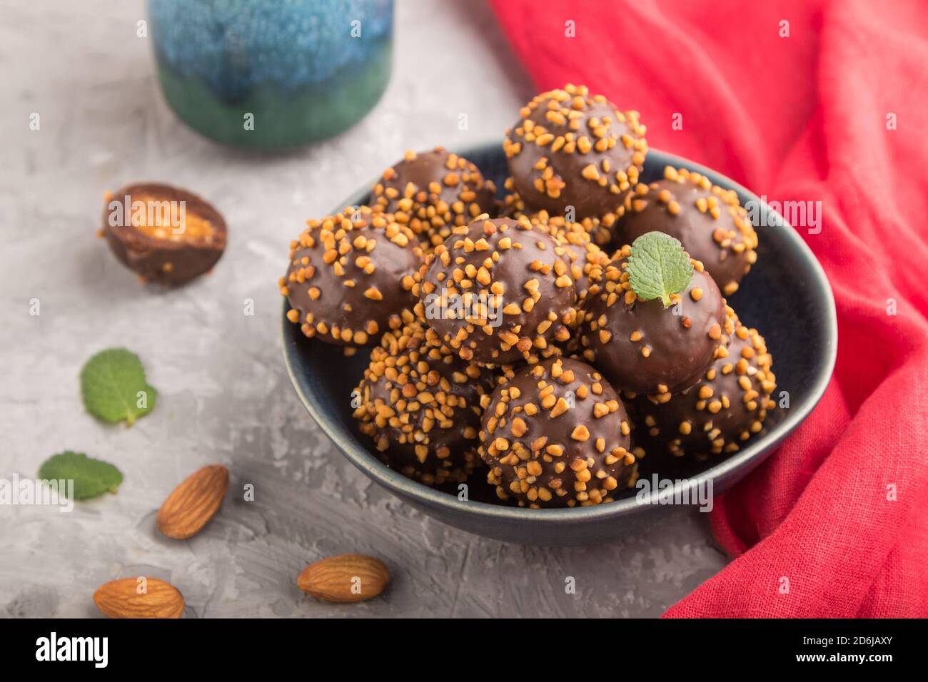 Chocolate caramel ball candies with almonds and a cup of coffee on a ...