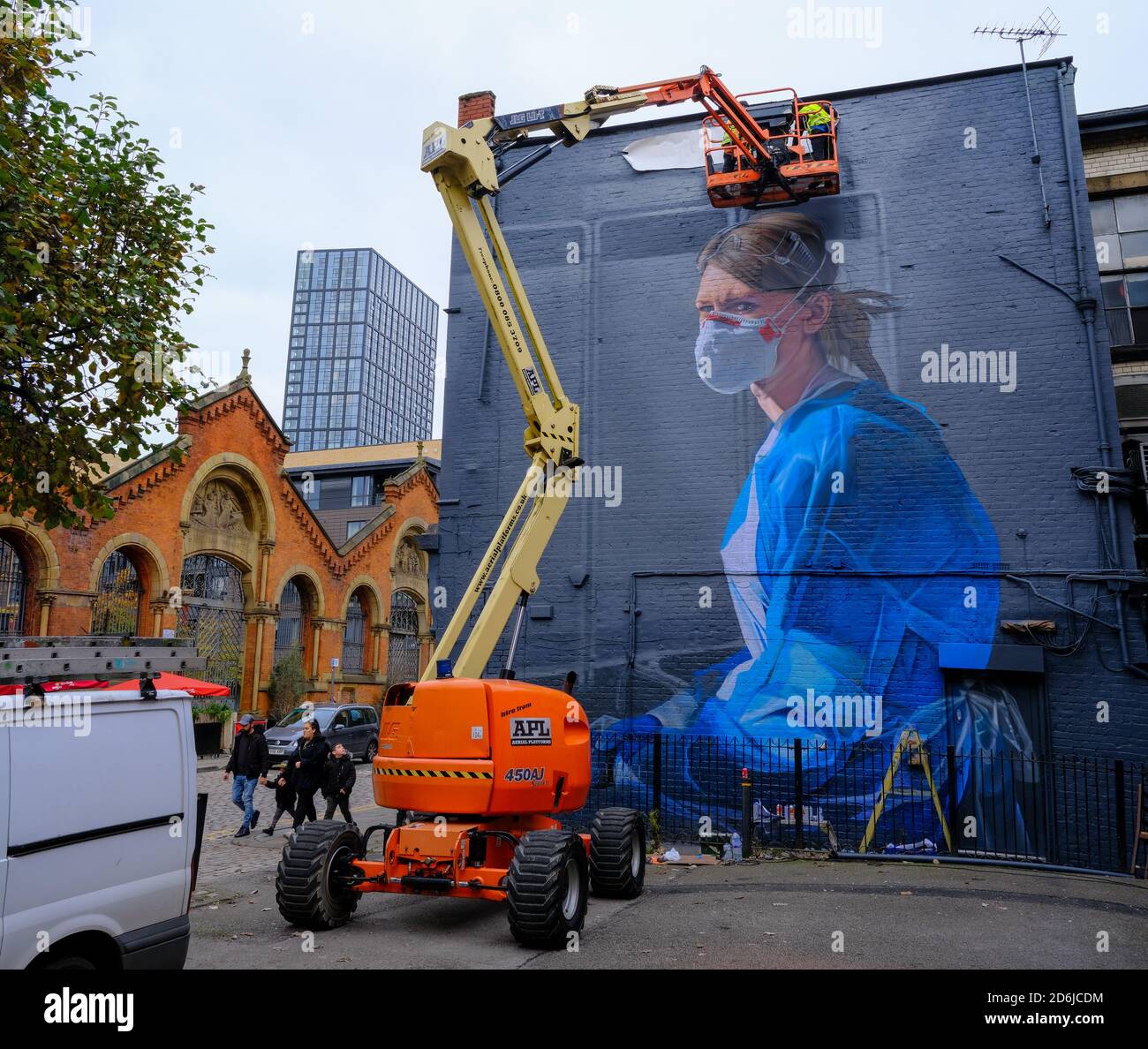 Artist Peter Barber works on a mural in Manchester depicting nurse ...