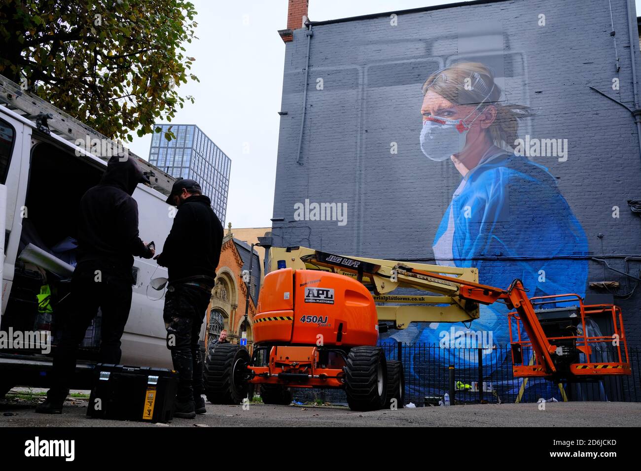 Artist Peter Barber works on a mural in Manchester depicting nurse ...