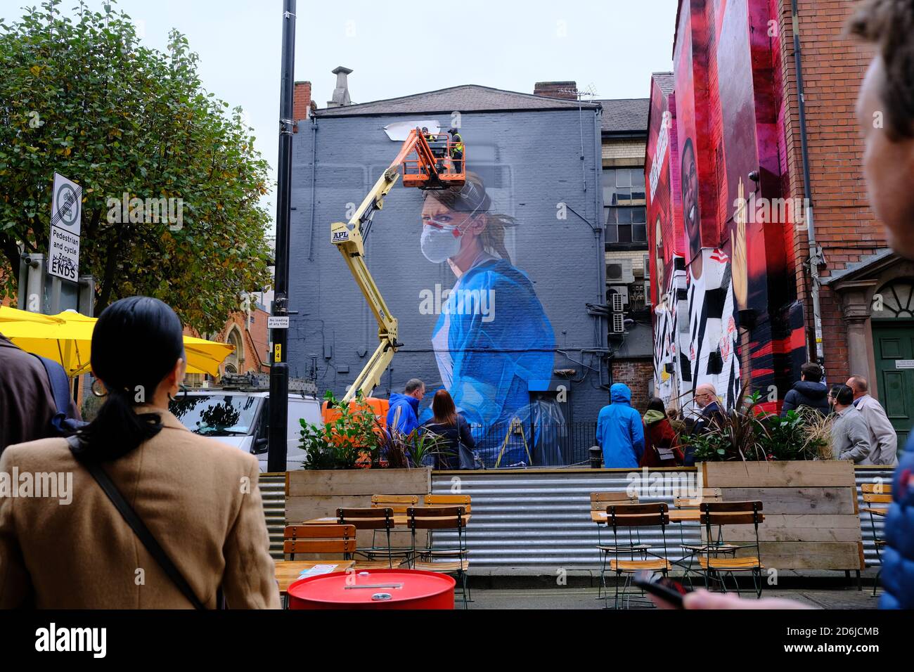 Artist Peter Barber works on a mural in Manchester depicting nurse ...
