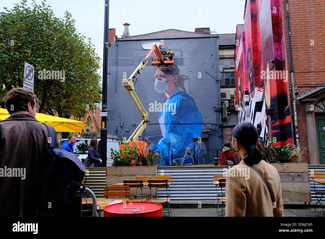 Artist Peter Barber works on a mural in Manchester depicting nurse ...