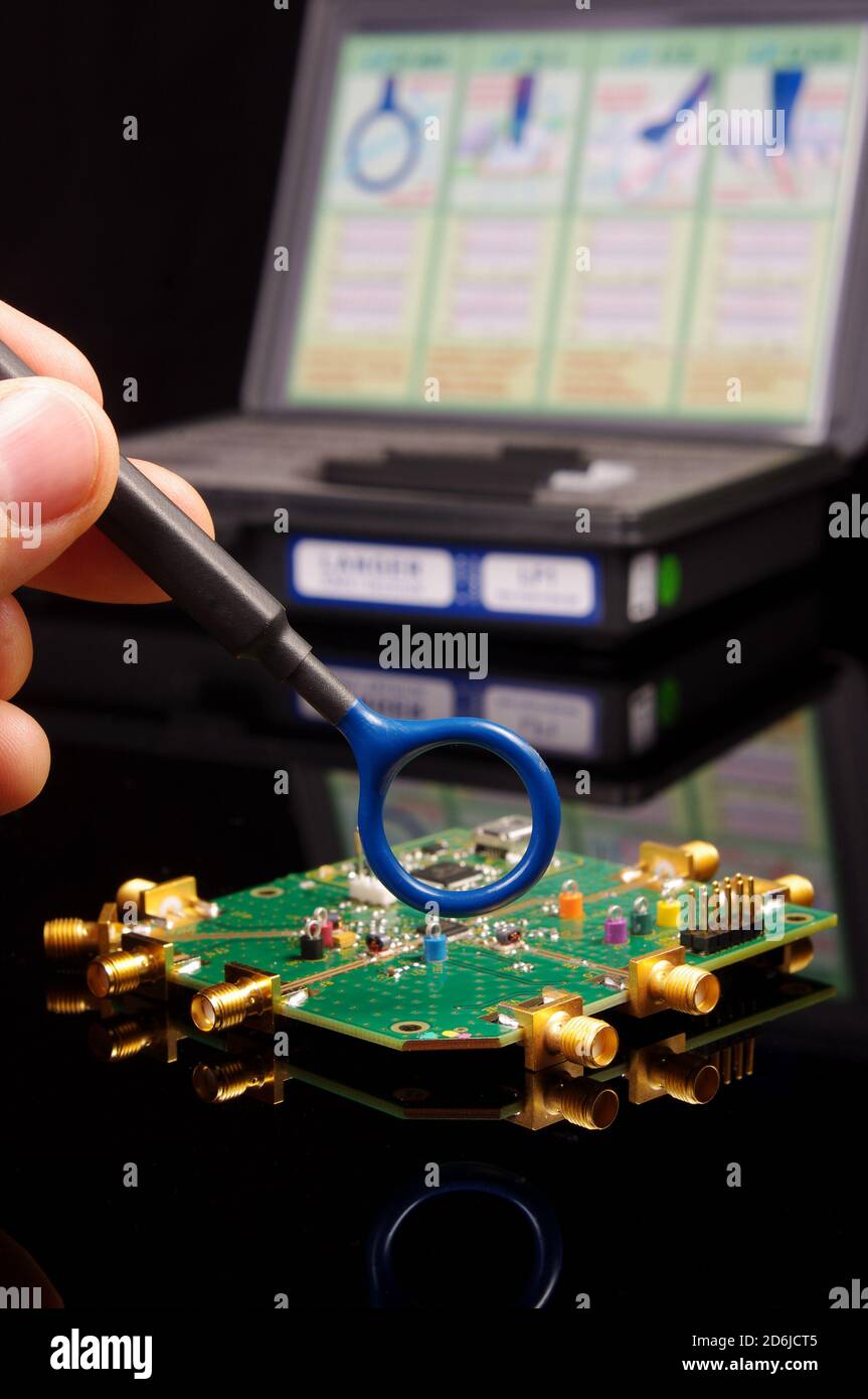 Electromagnetic compatibility (EMC) engineer holding magnetic near ...