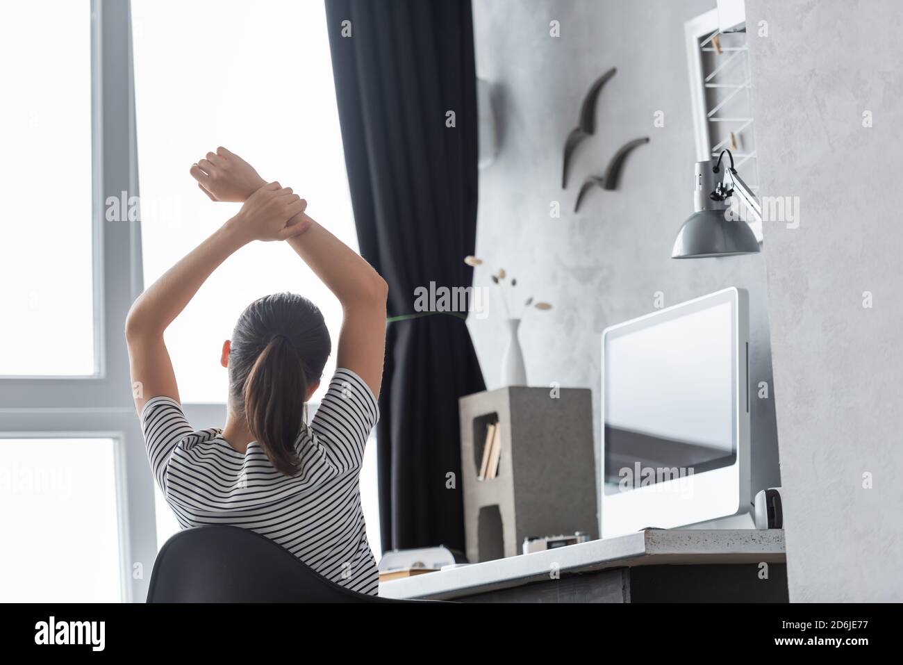 One woman on computer at home back view hi-res stock photography and ...