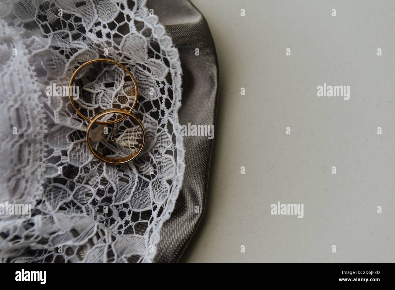 Top view of a pair of wedding rings on a white lace background Stock ...