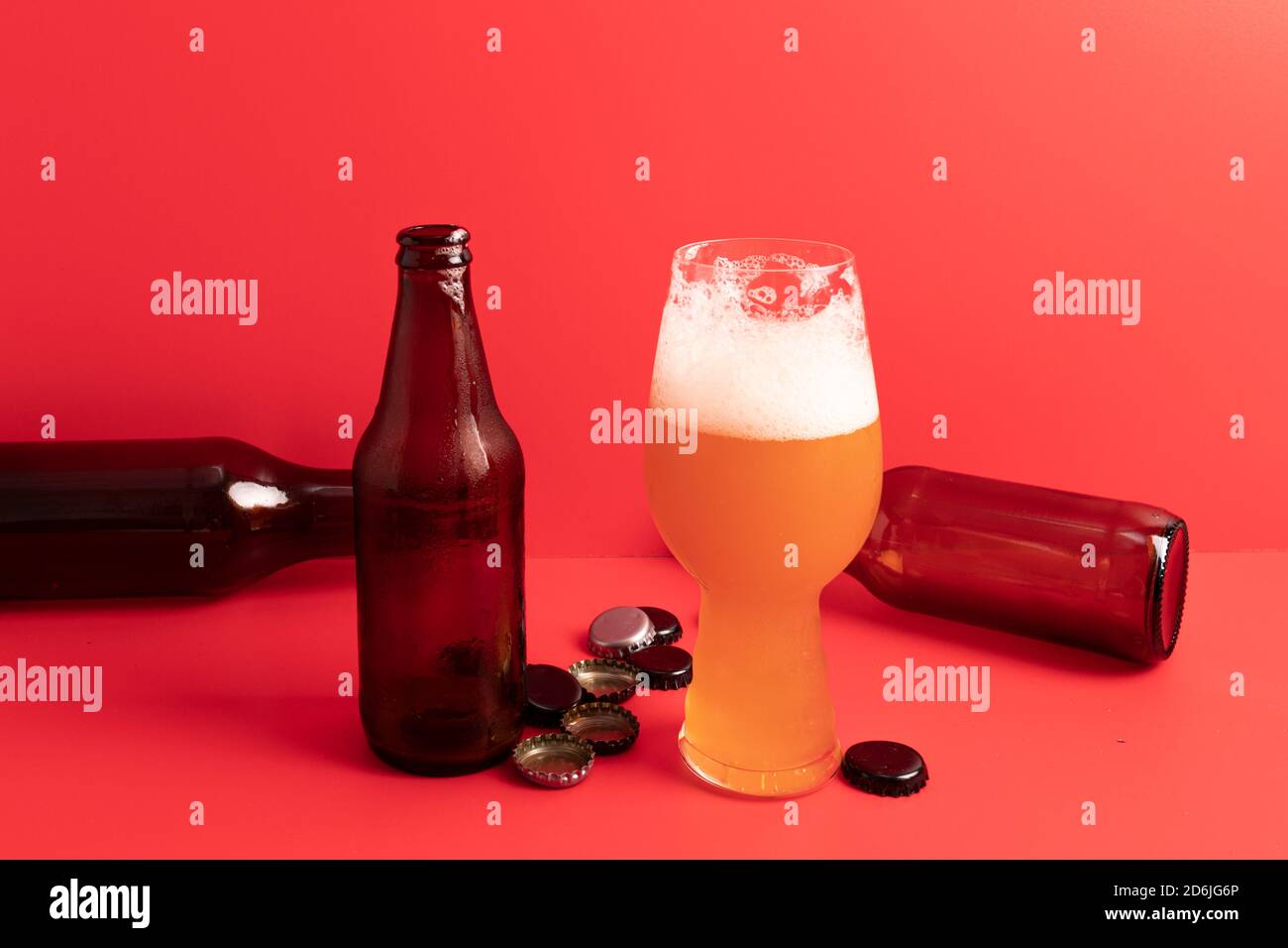 IPA beer glass and various bottles with red background Stock Photo - Alamy