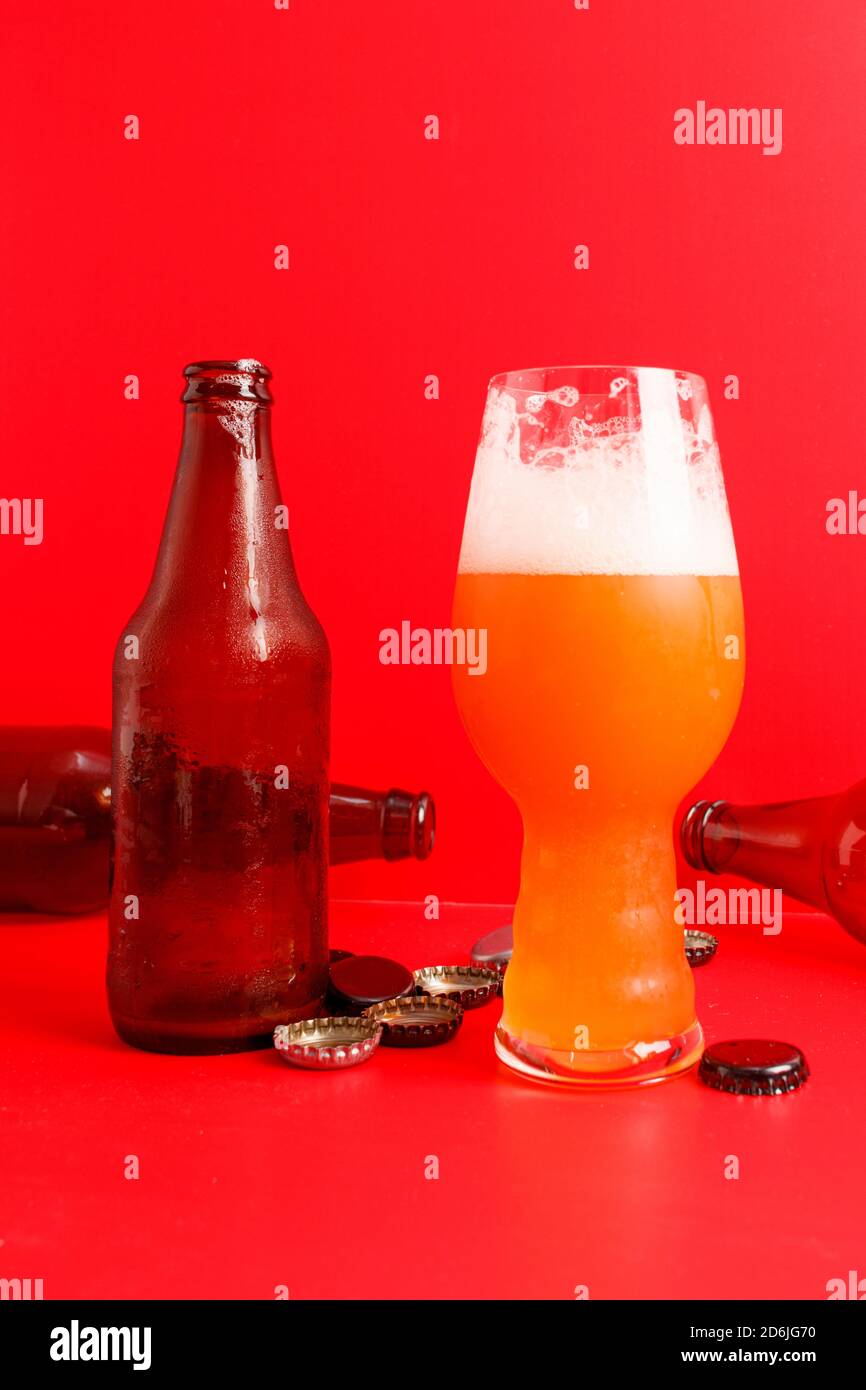 IPA beer glass and various bottles with red background Stock Photo - Alamy