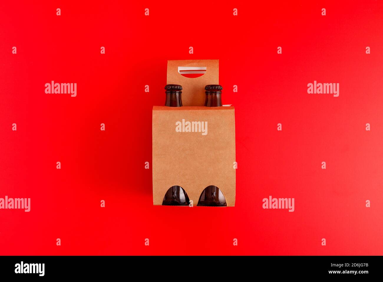 Presentation of pack of four beers with red background Stock Photo - Alamy