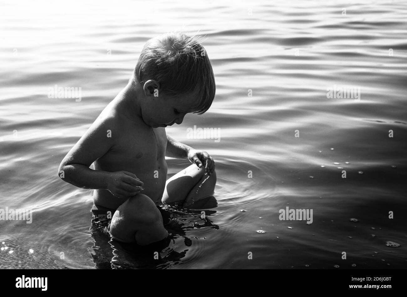 Boy in the water, B&W portret. Water is calming Stock Photo - Alamy