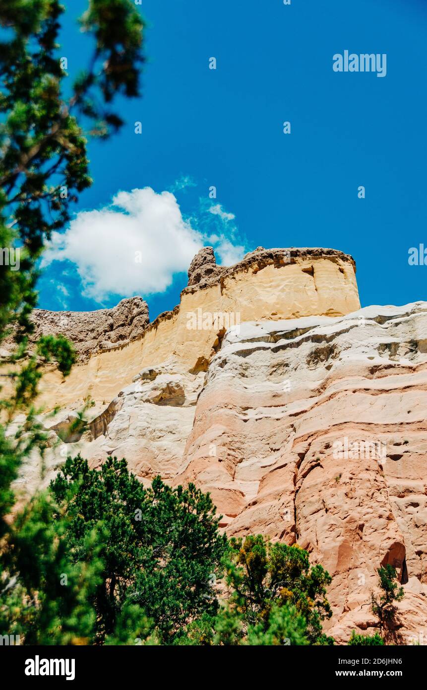 Colorful cliff walls in the high desert of New Mexico with a blue sky ...