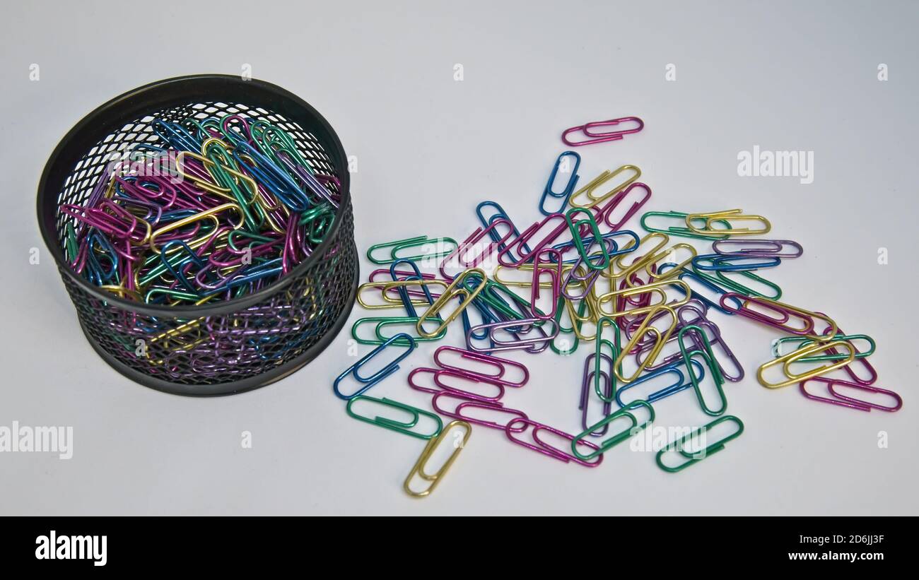 Colourful paper clips and a black container Stock Photo - Alamy