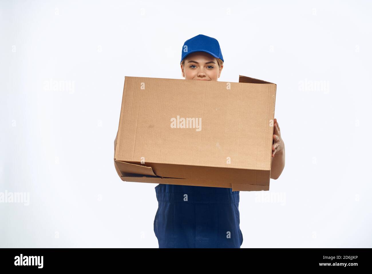 A woman in a working uniform with a box in the hands of a delivery ...