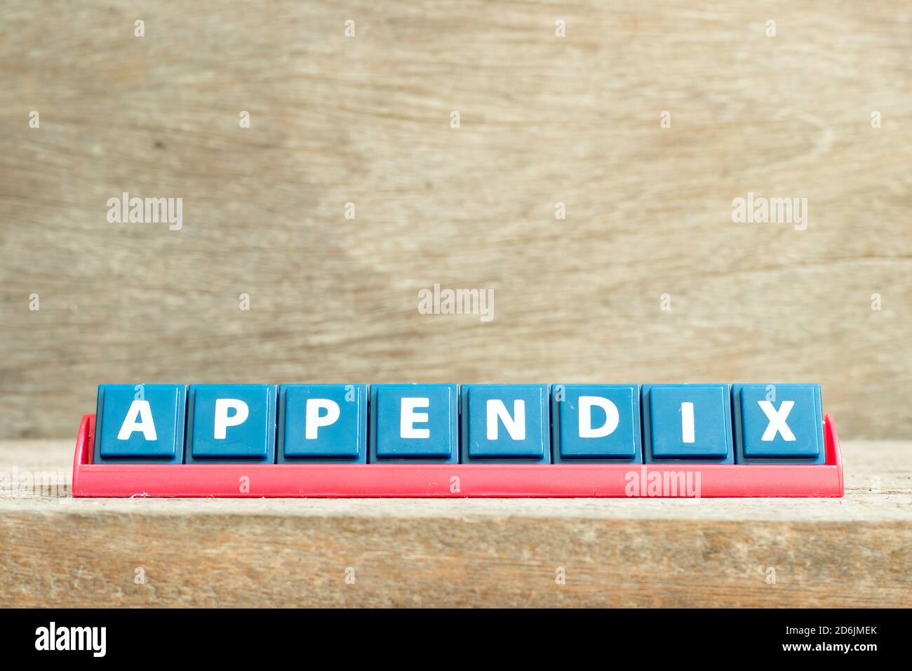 Tile letter on red rack in word appendix on wood background Stock Photo ...