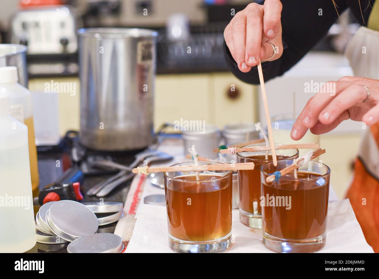 Creative occupation of candle making showing the pouring of liquid wax ...