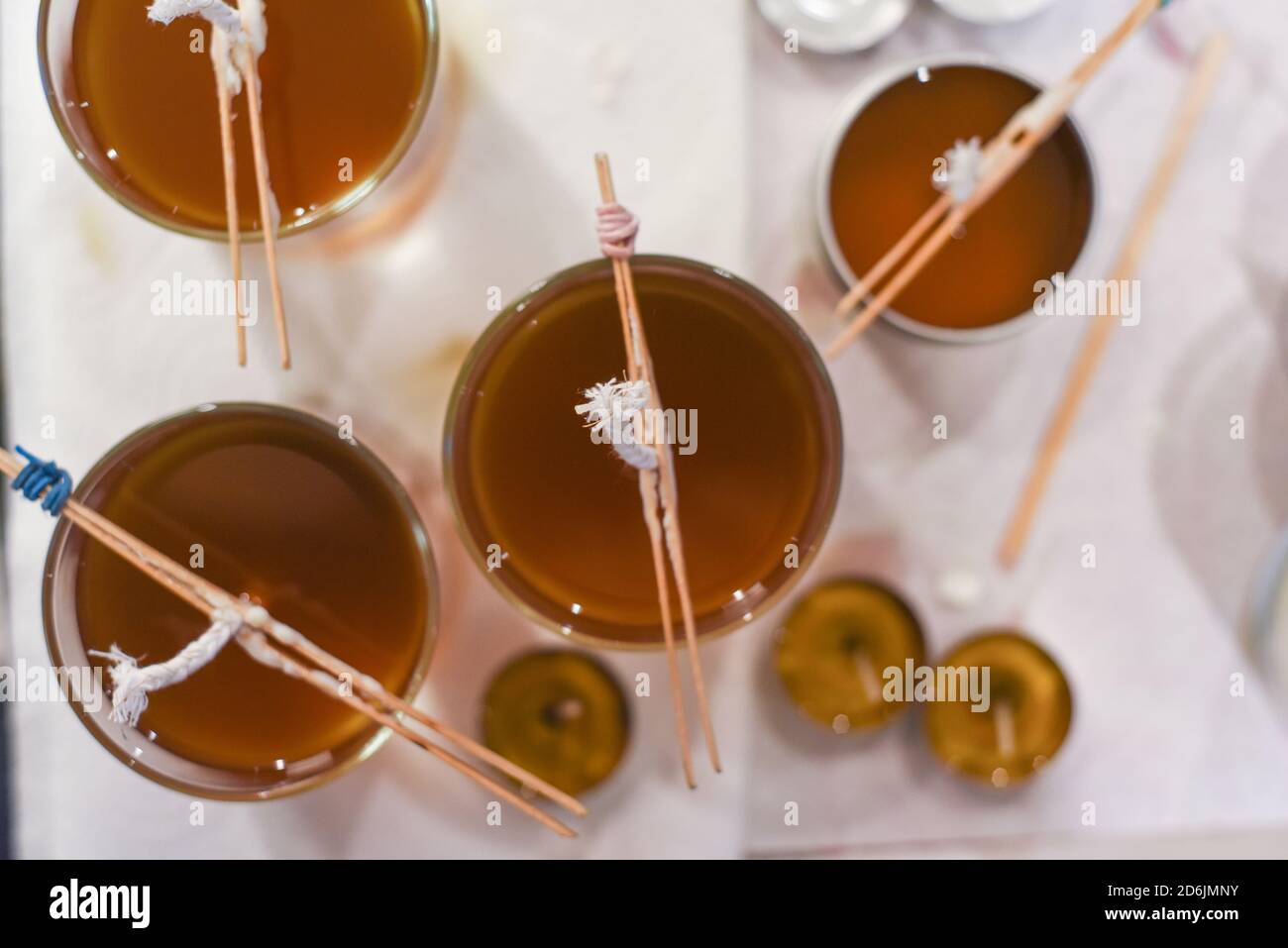 Creative occupation of candle making showing the pouring of liquid wax ...