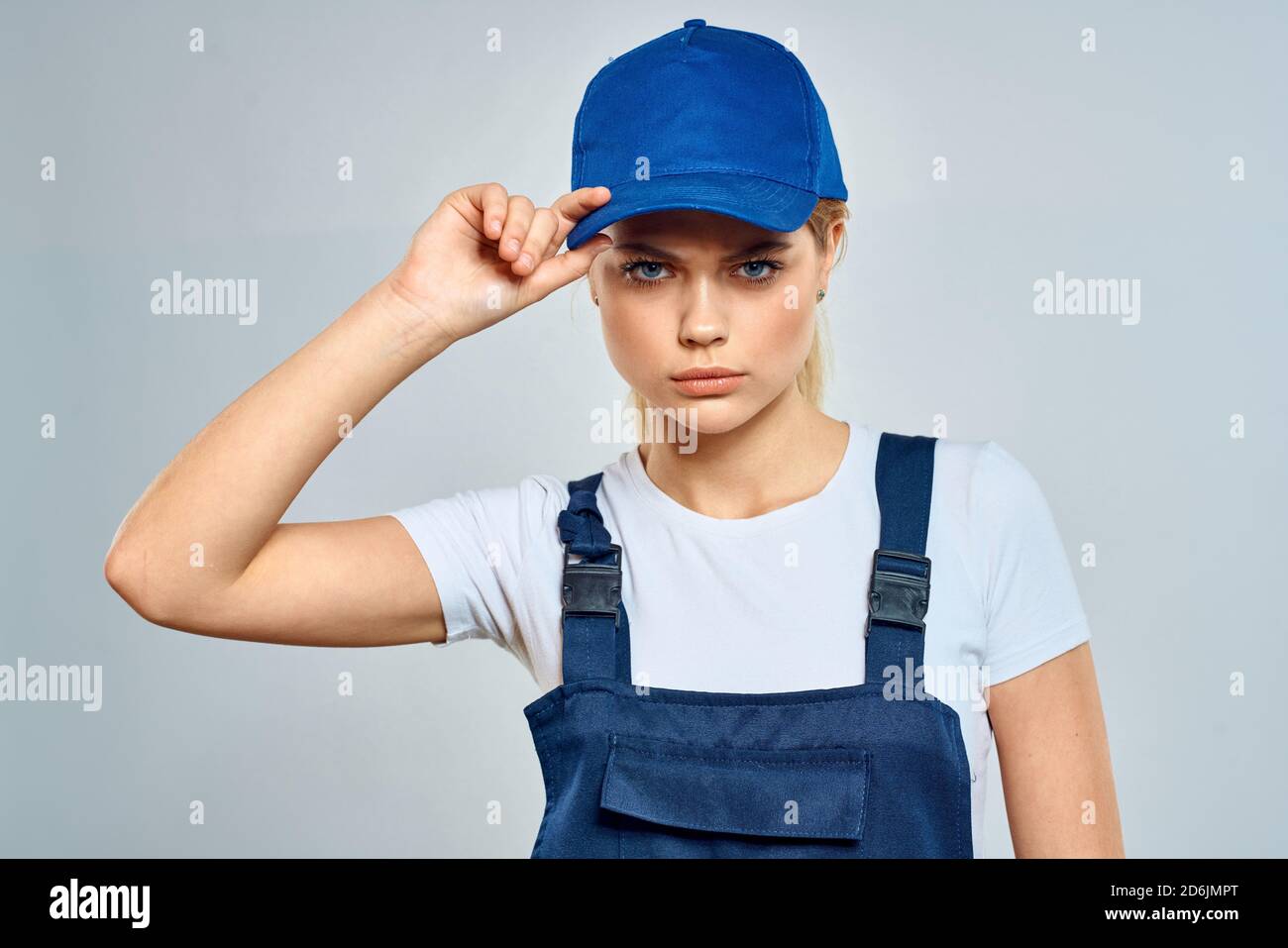 Woman in working uniform blue cap service lifestyle service Stock Photo ...