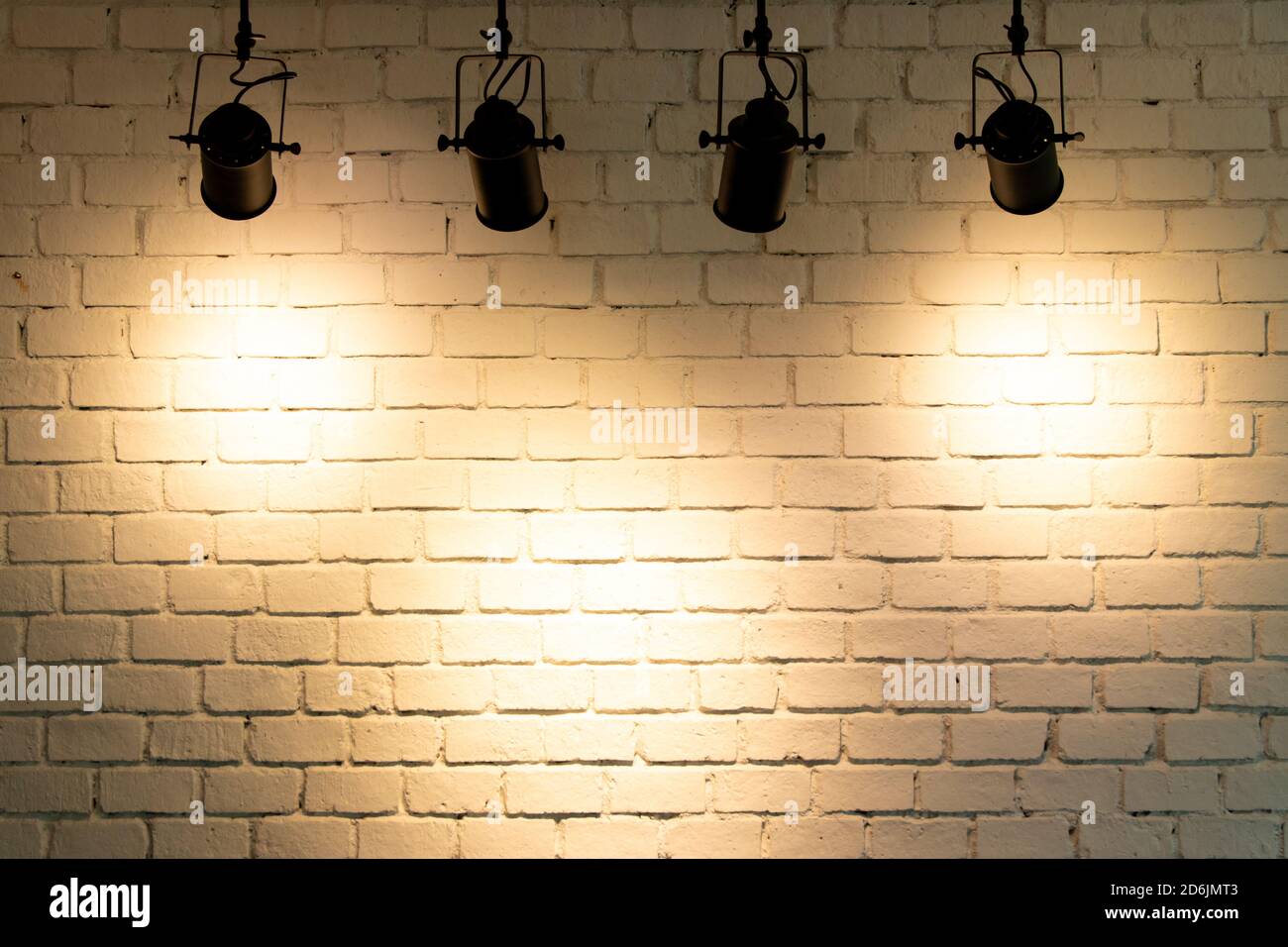 Hanging spotlight illuminate at brick wall background with copy space ...