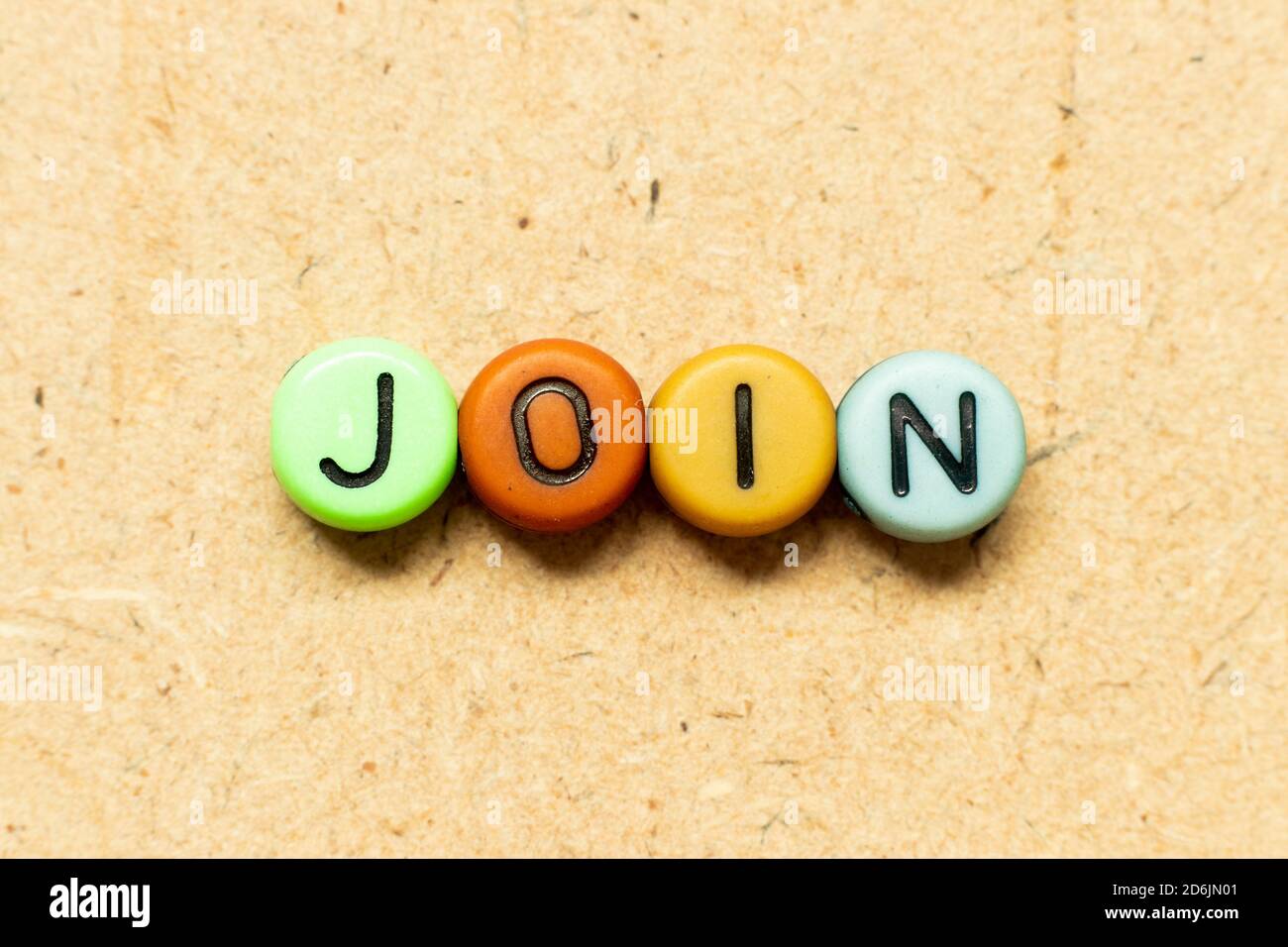 Round color bead with black letter in word join on wood background ...