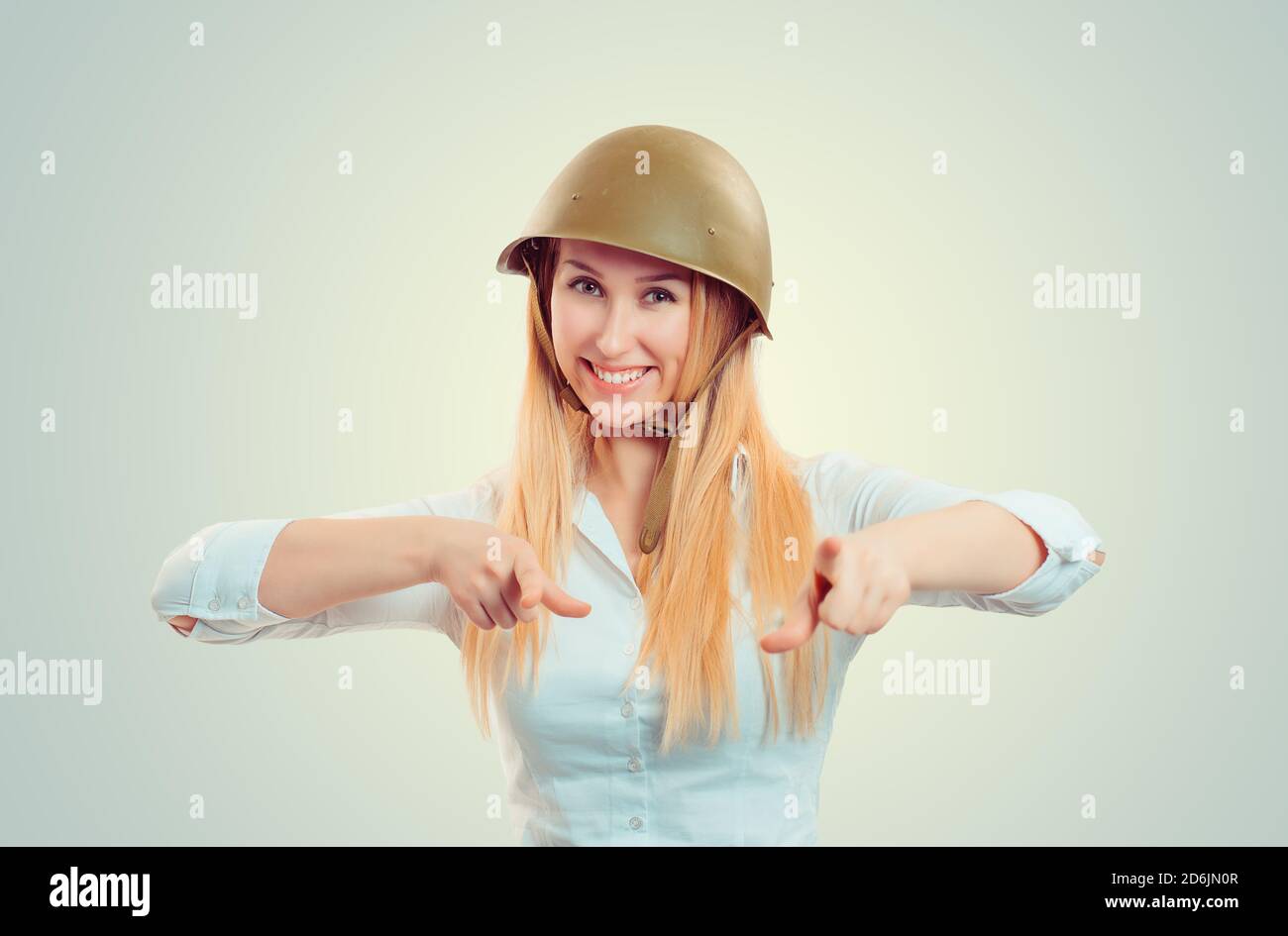 Woman in military armor cap helmet of World War II period pointing ...
