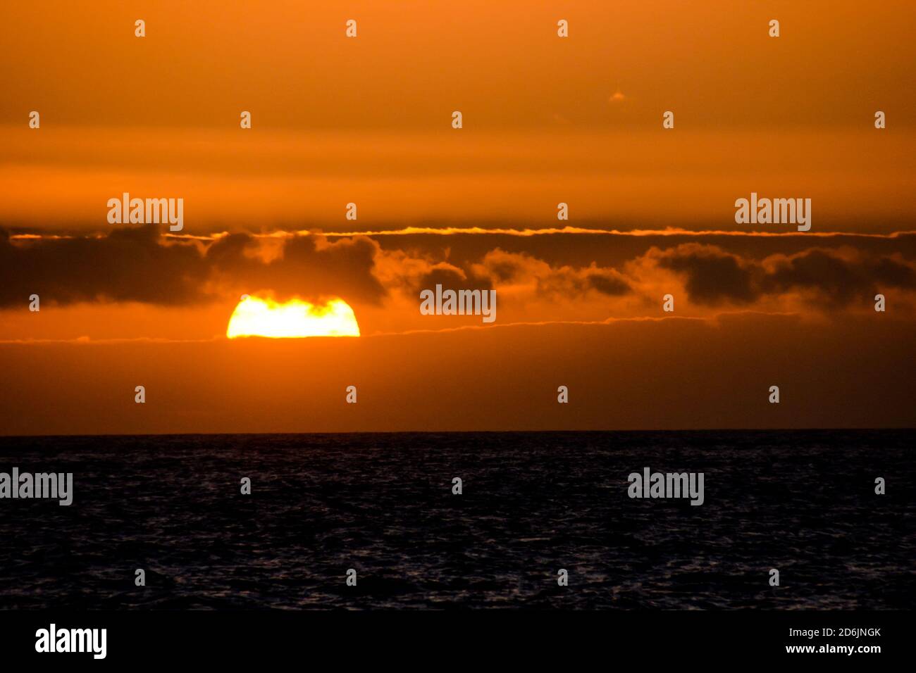 The Sun Setting in the Sea Stock Photo - Alamy