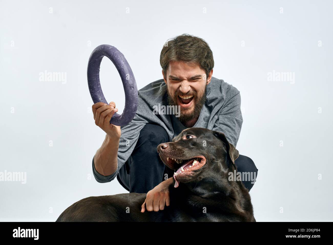 happy owner with pet black dog training model emotions Stock Photo - Alamy
