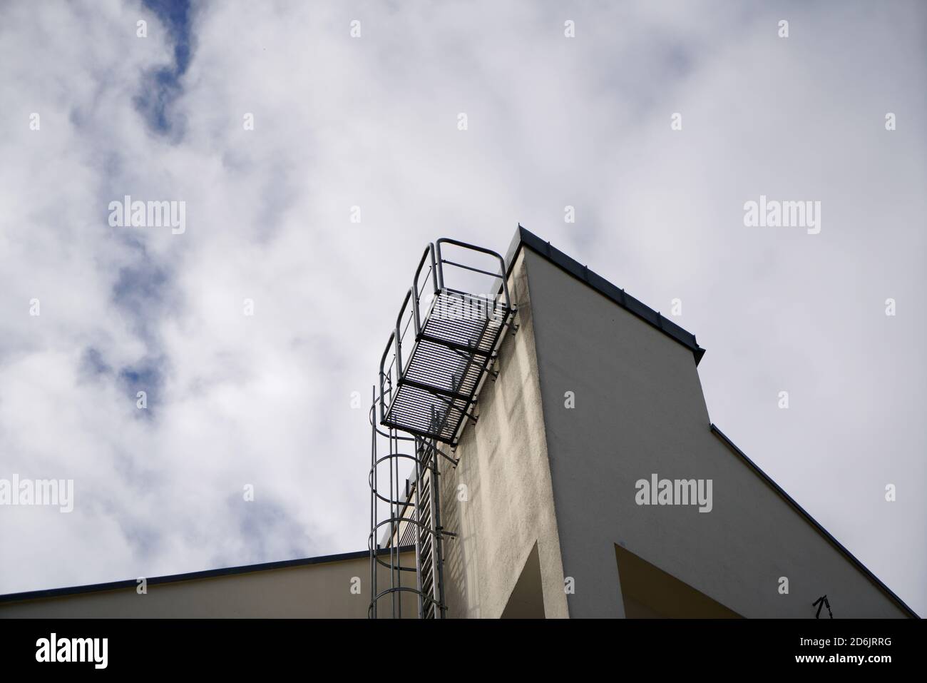 Low angle shot of an emergency exit ladder of a tall building against a ...
